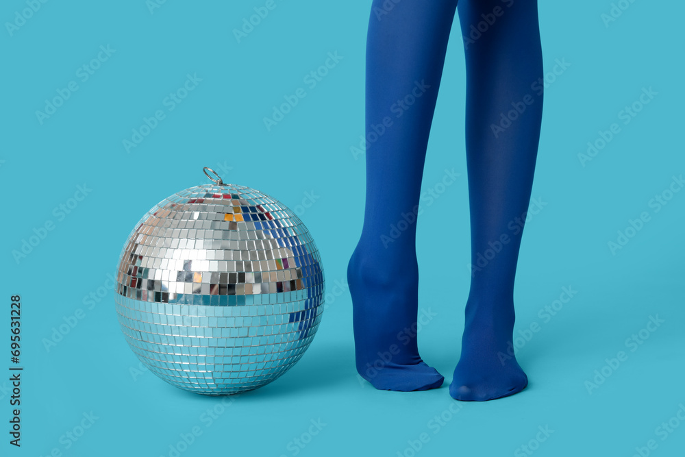 Female legs in stylish tights with disco ball on blue background Stock ...