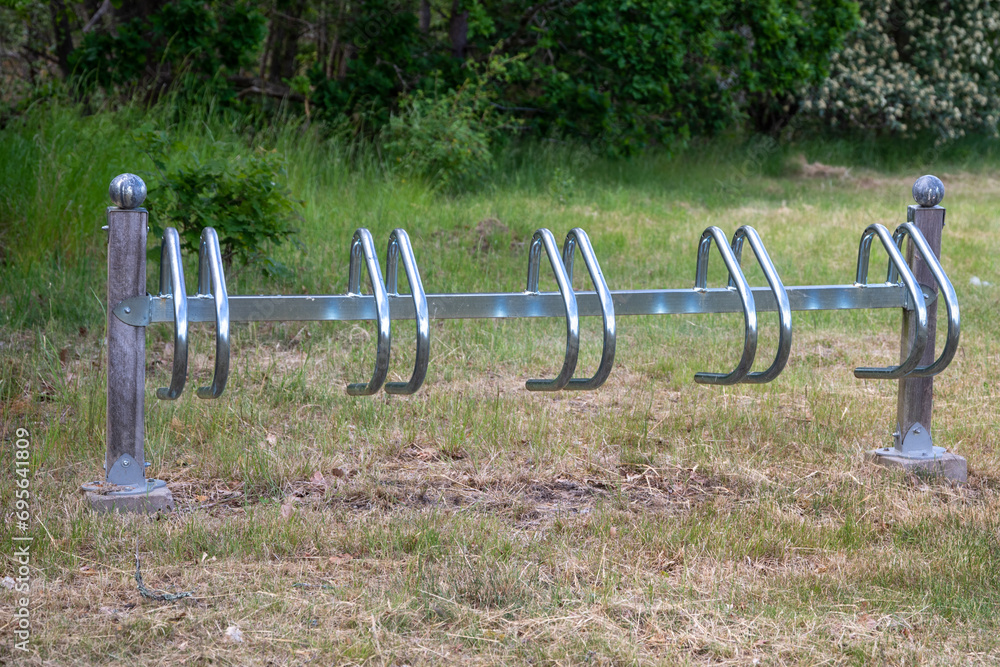bike wheel racks of gray sheet metal tubes in the shape of a rectangle ...