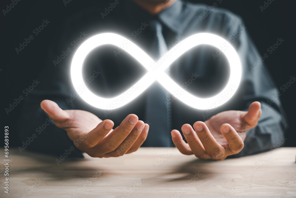 Circular infinity symbol held by businessman, representing circular ...