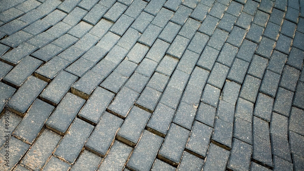 Defect in the road surface of artificial paving stones. Damage to the ...