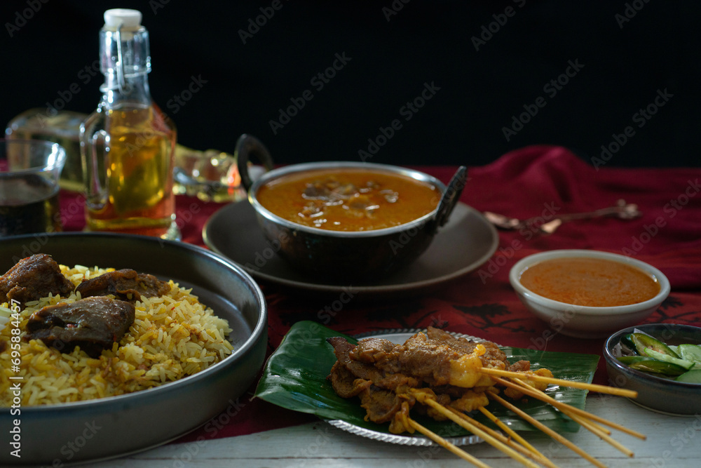 Muslim food including beef biryani, masala curry, beef satay is placed ...