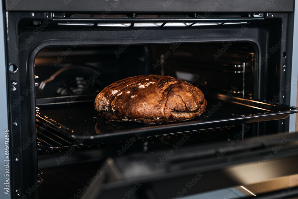 Freshly Baked Loaf of Bread in Modern Oven. Homemade baked artisanal ...