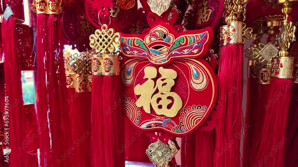 Traditional Chinese red decorations with golden accents and characters ...