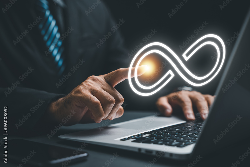 Businessman emphasizes infinity symbol, indicating unlimited connection ...