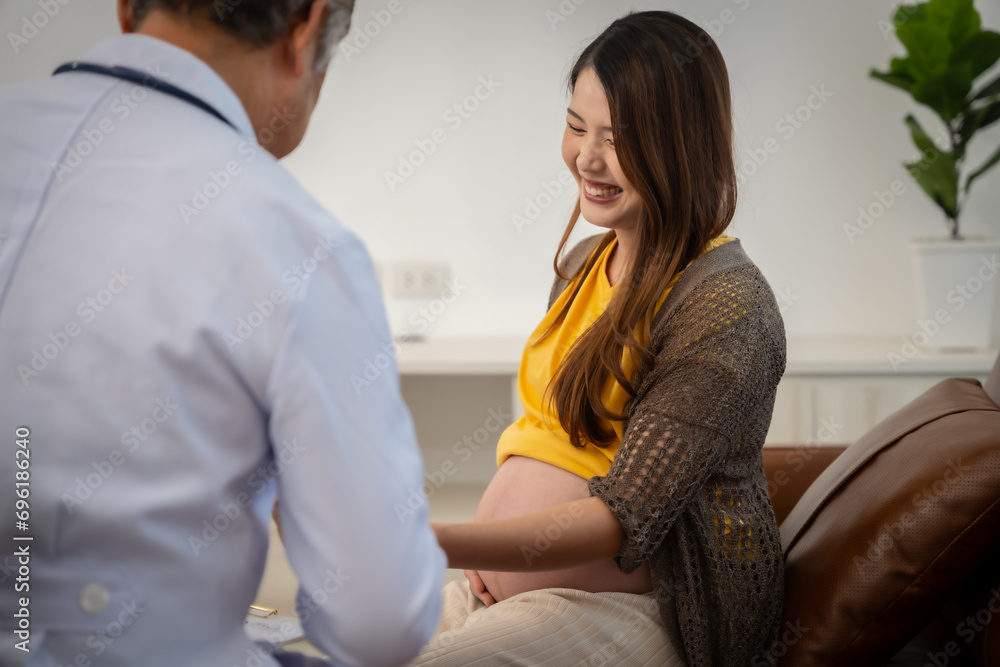 Asian woman who is pregnant Currently receiving a health check from a ...