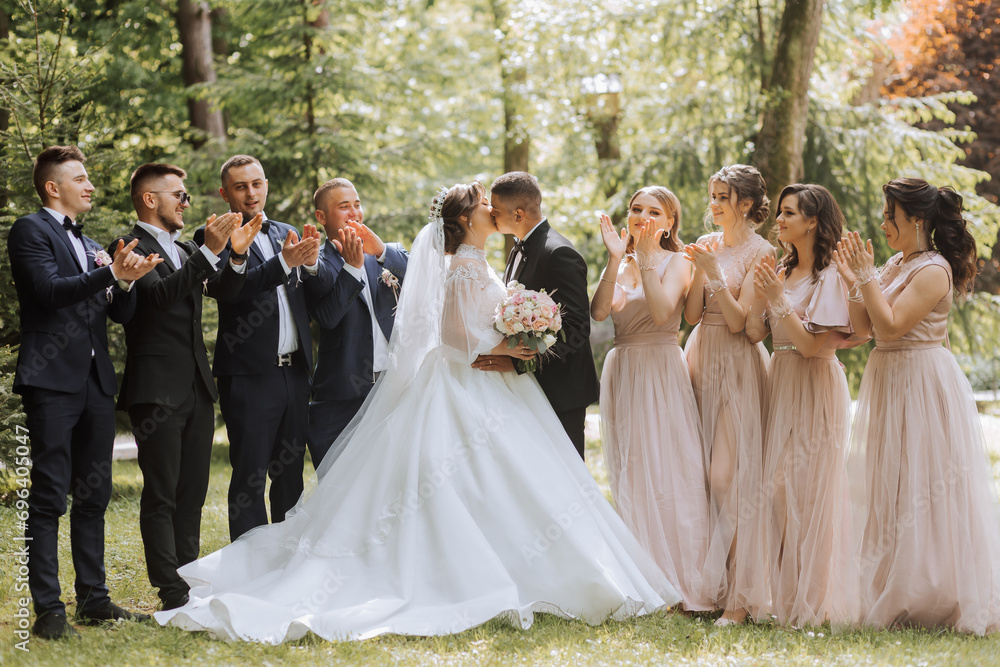 full-length portrait of the newlyweds and their friends at the wedding ...