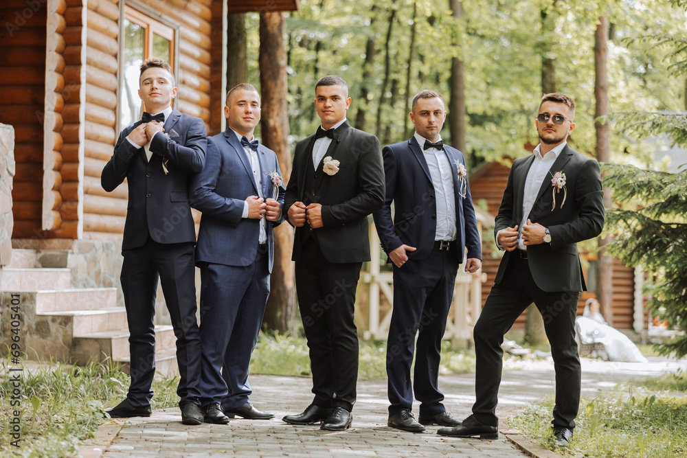 Cheerful, young, energetic witnesses of the groom next to the groom ...