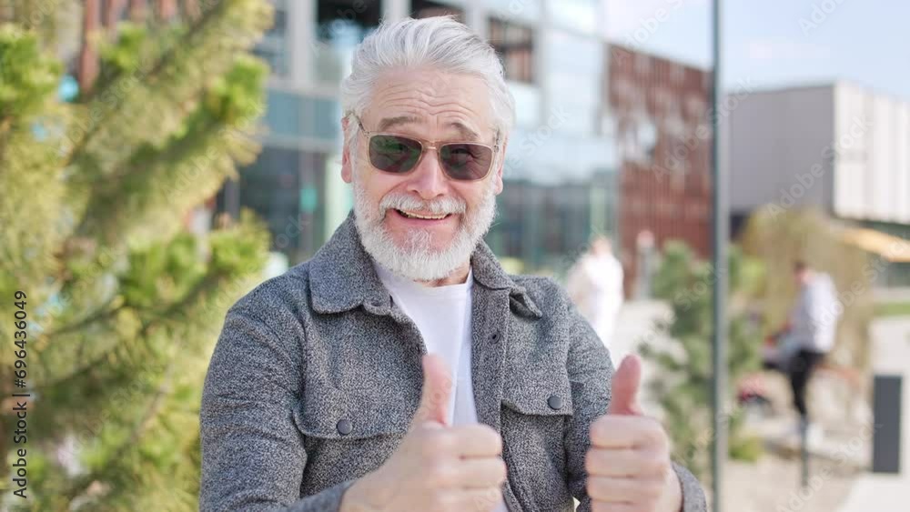 Portrait of glad senior person showing excitement and making thumbs up ...