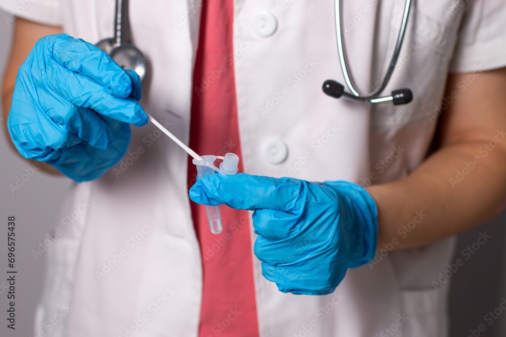 Doctor in a hospital using rapid antigen test kit for self test COVID ...