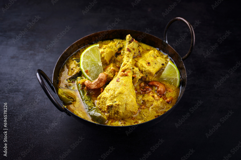 Traditional spicy Indian chicken Madras curry with drumsticks, cashew ...