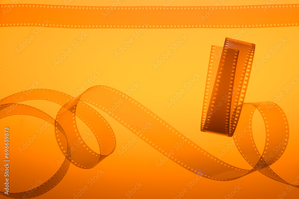 color cinema background with film strip.orange gold background with ...