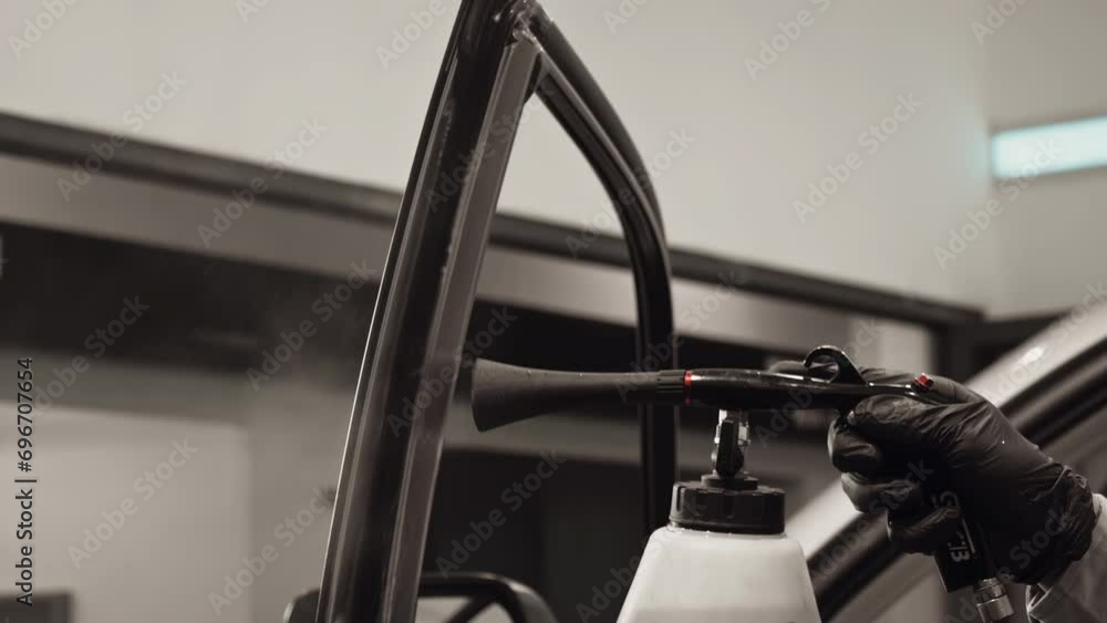 Professional engineer wearing black gloves expertly using tornado gun ...