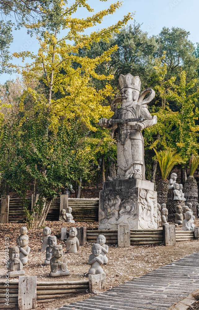 Statue of god warrior in Oriental garden, also known as Buddha Eden, in ...