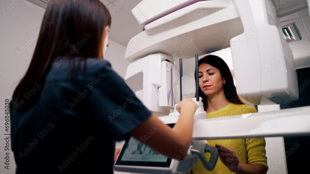 a female doctor makes a 3D scan of the nose and oral cavity of a ...