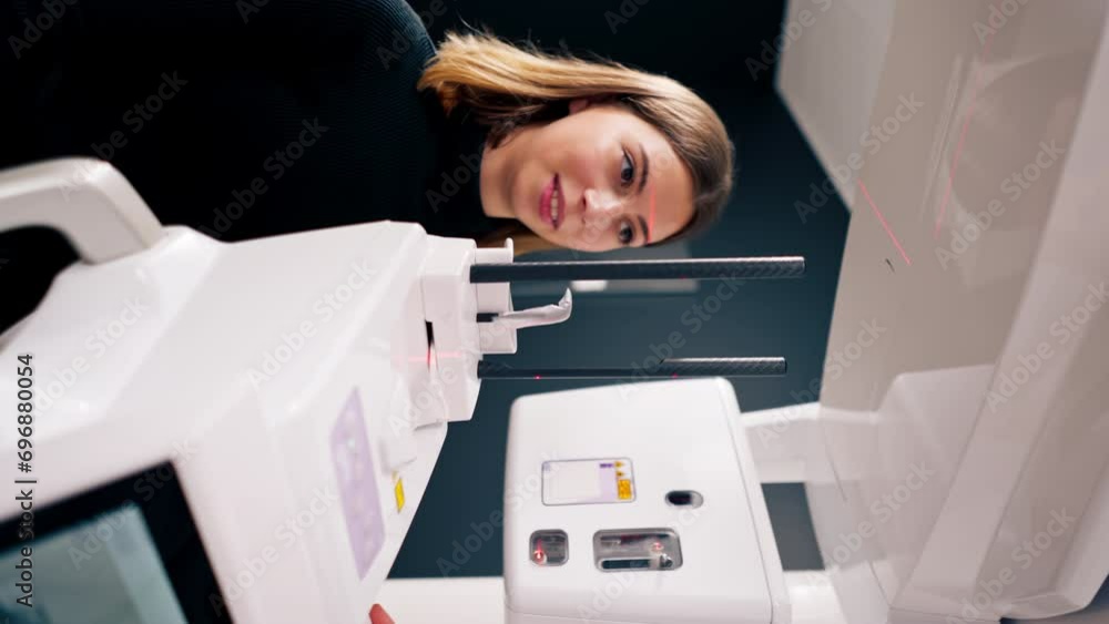 vertical video portrait of a beautiful woman doing a 3D scan of the ...