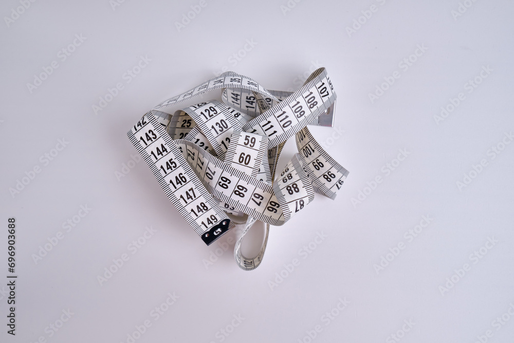 White measuring tape on a white background. Tool for measuring length ...