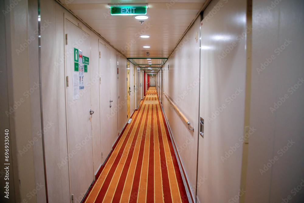 Corridor with cabins on the deck of the cruise ship. Inside a passenger ...