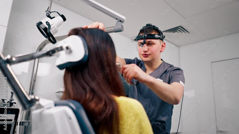 the ENT doctor examines the patient in the office of the clinic, checks ...
