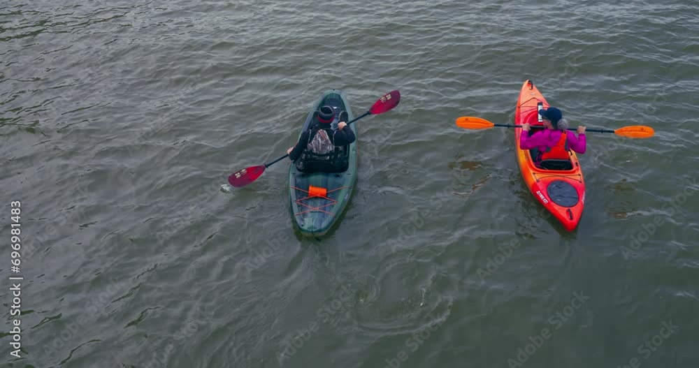 Two people in kayaks glide over Lake Ontario top view cinematic shot ...