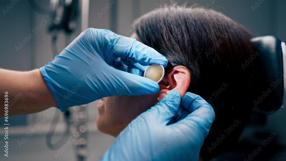 close-up ENT doctor examines the patient's ears in the office of the ...