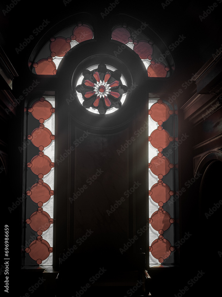 Church door with stained glass window through a dark room with ...