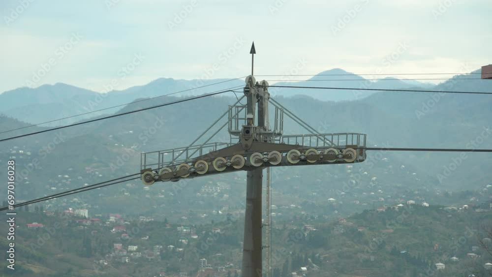 Support of ski lift with rotating rollers. Cable car passes by the ...