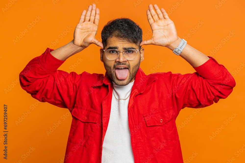 Displeased Indian man showing tongue making faces at camera, fooling ...