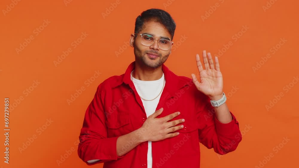 I swear to be honest. Sincere responsible Indian man raising hand to ...
