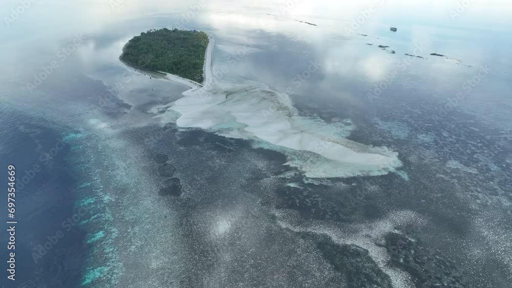 Early morning light illuminates the remote island of Koon near Seram ...