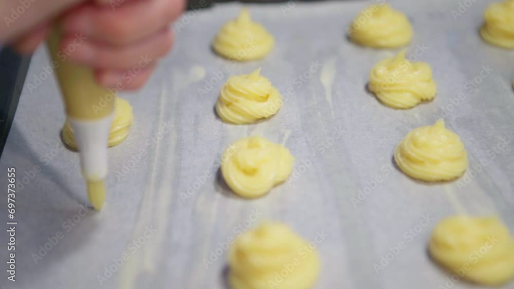 4K video of female hands squeeze out cookies dought using confectionery ...