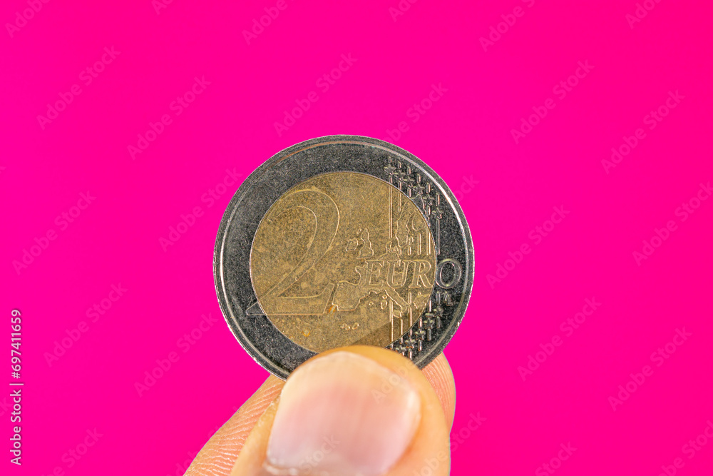 2 euro coin face held between thumb and index finger Stock Photo ...