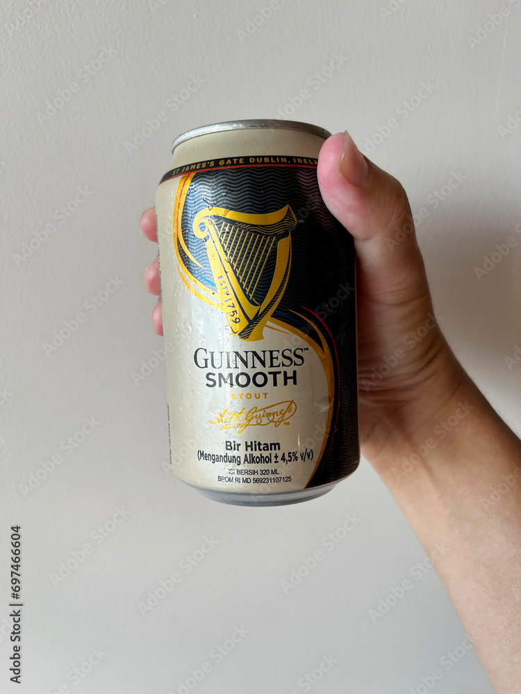 GUINESS SMOOTH beer in man's hand at Nusa Dua Indonesia Stock Photo ...