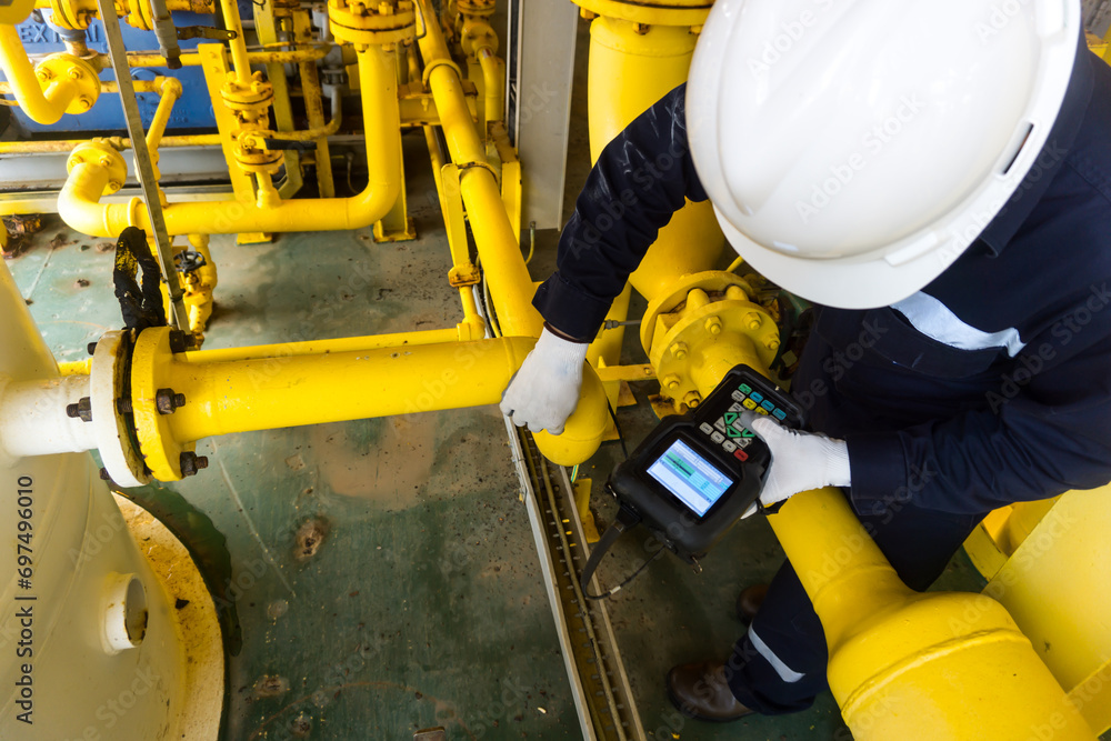 Non-destructive testing technicians are checking the thickness of elbow ...