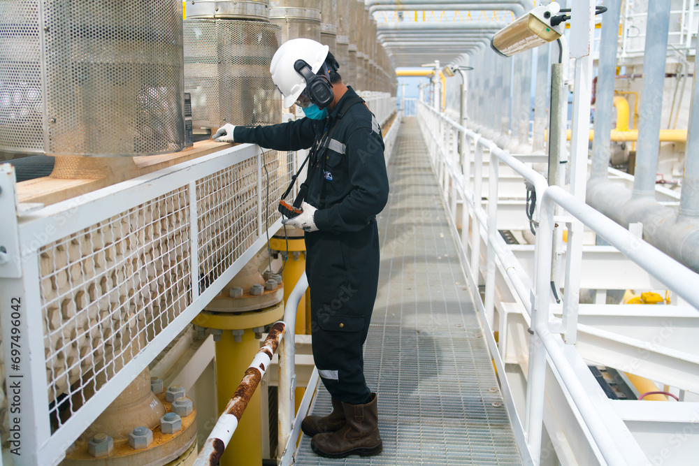 Non-destructive testing technicians are checking the thickness of pipes ...