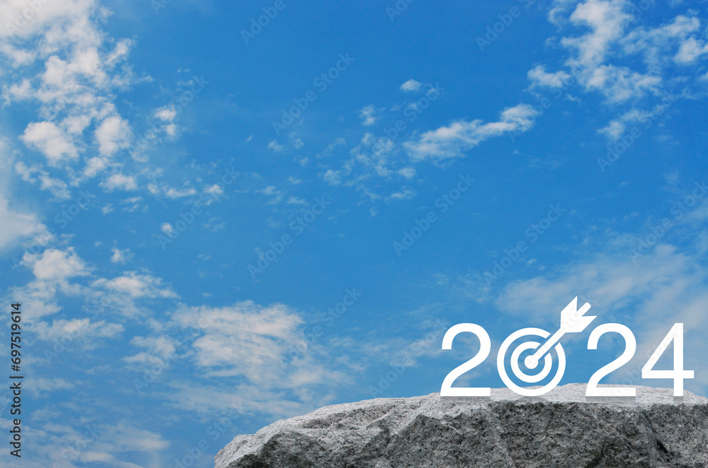 2024 letter with goal icon on rock mountain over blue sky with white ...