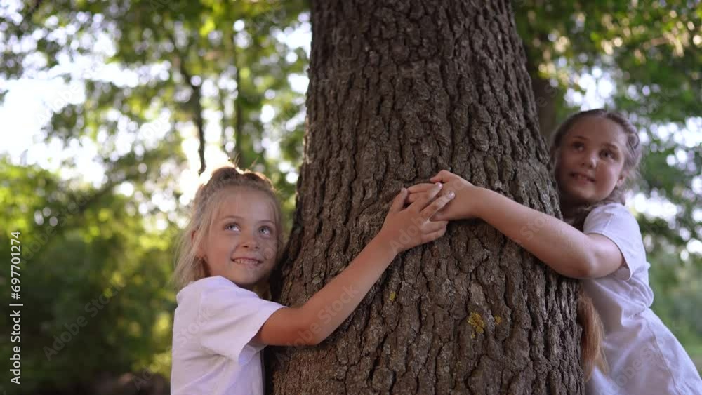 Vidéo Stock children hugging a tree in the forest. happy family ...