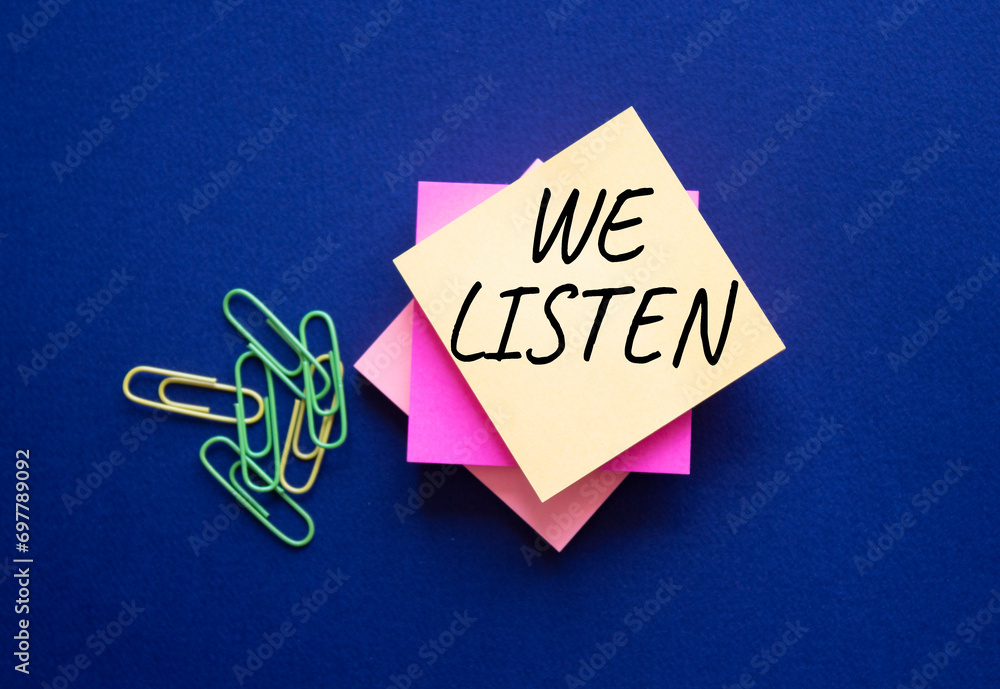 We listen symbol. Orange steaky note with words We listen. Beautiful ...