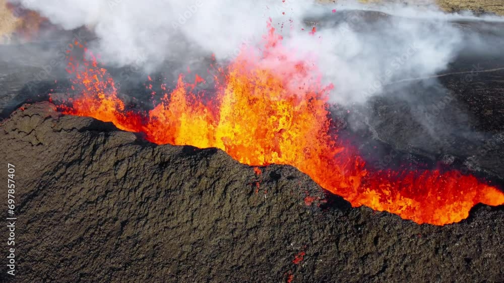 Volcano eruption, red hot burning lava erupts from ground, drone fly ...