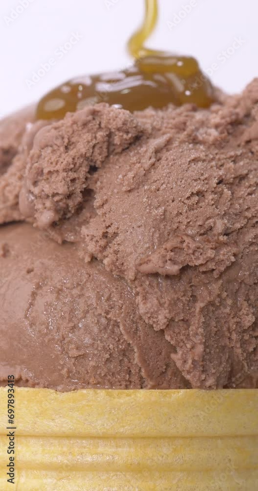 Vertical video Front view SLO MO Extreme Close-up, Drizzle caramel over ...