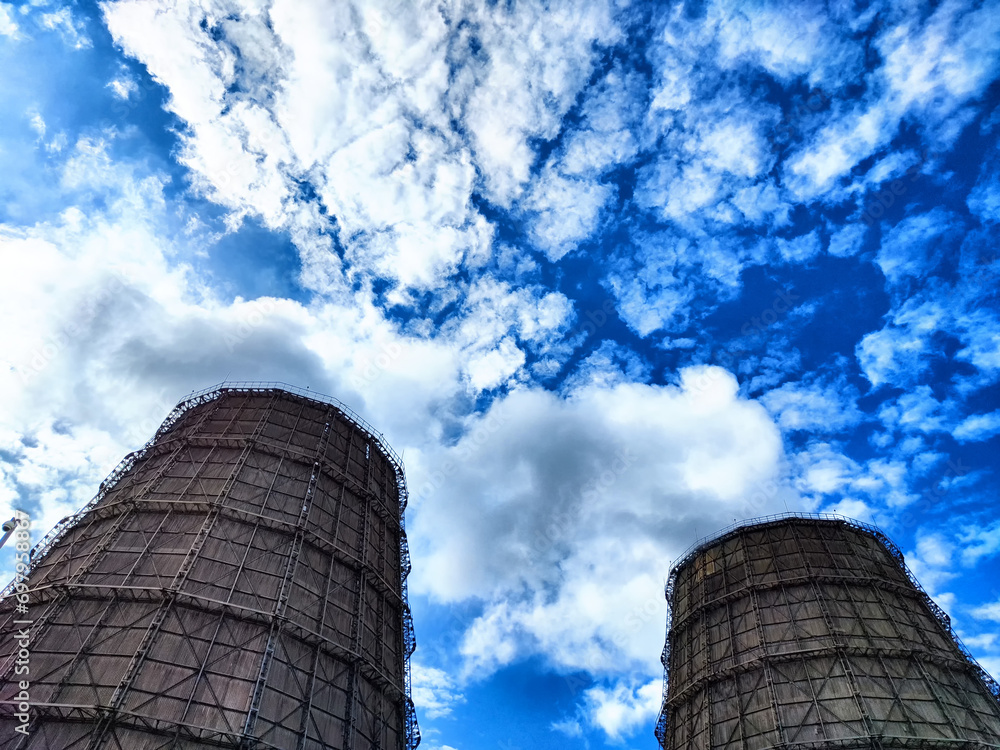 Big tower of CHPP close-up. White steam from wide pipe of CHP on blue ...
