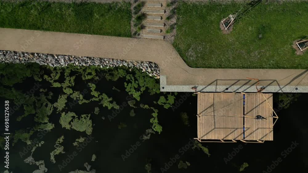 Pier for park visitors. two steps lead to it. planks terrace over water ...
