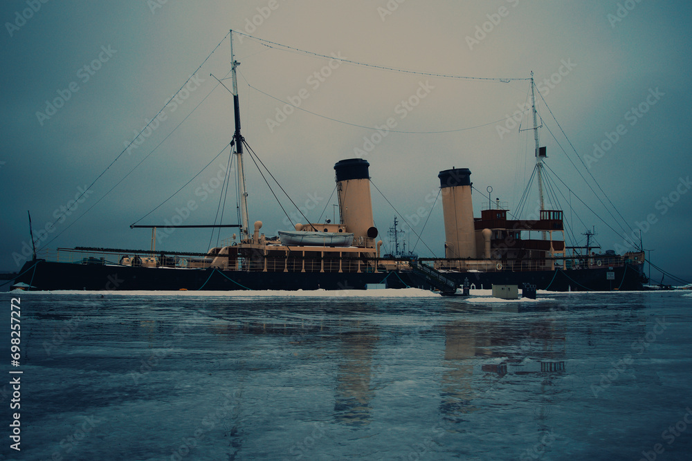 An old icebreaker ship is at the quay of the harbor. Oldest steam ...