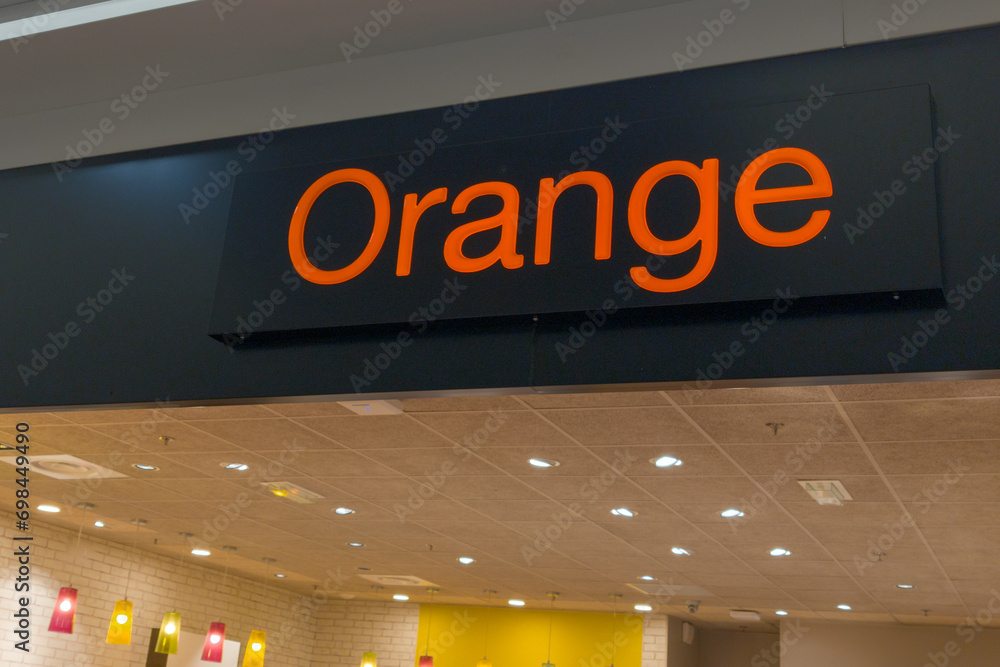 Orange store logo sign and brand text facade boutique entrance shop ...