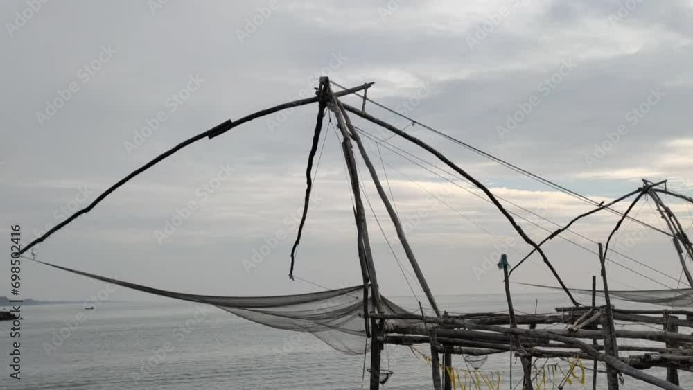 Traditional big Chinese fishing net in the Arabian Sea with ocean and ...