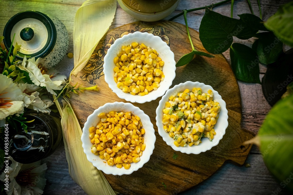 Corn Chaat, Corn served in white bowl on wooden background top view ...