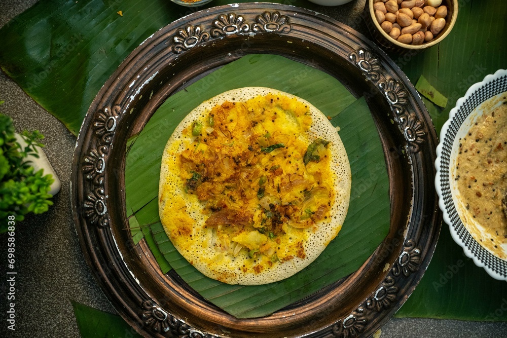South Indian Food Uttapam on banana leaf in copper plate, oothappam ...