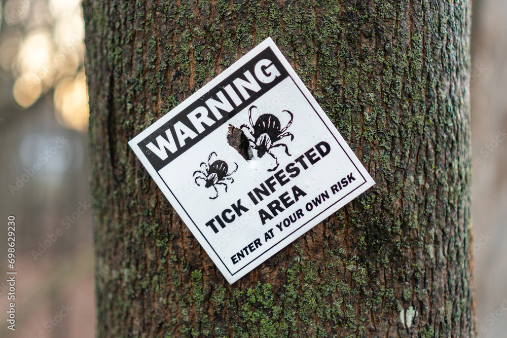 Sign in forest with words Warning Tick Infested Area Stock Photo ...