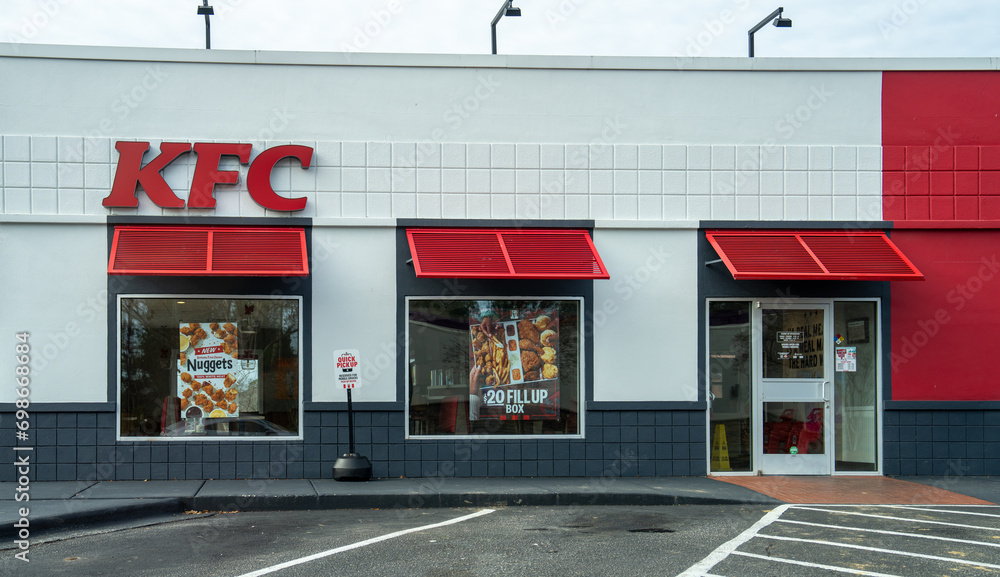 KFC fast-food restaurant storefront with promotional window displays ...