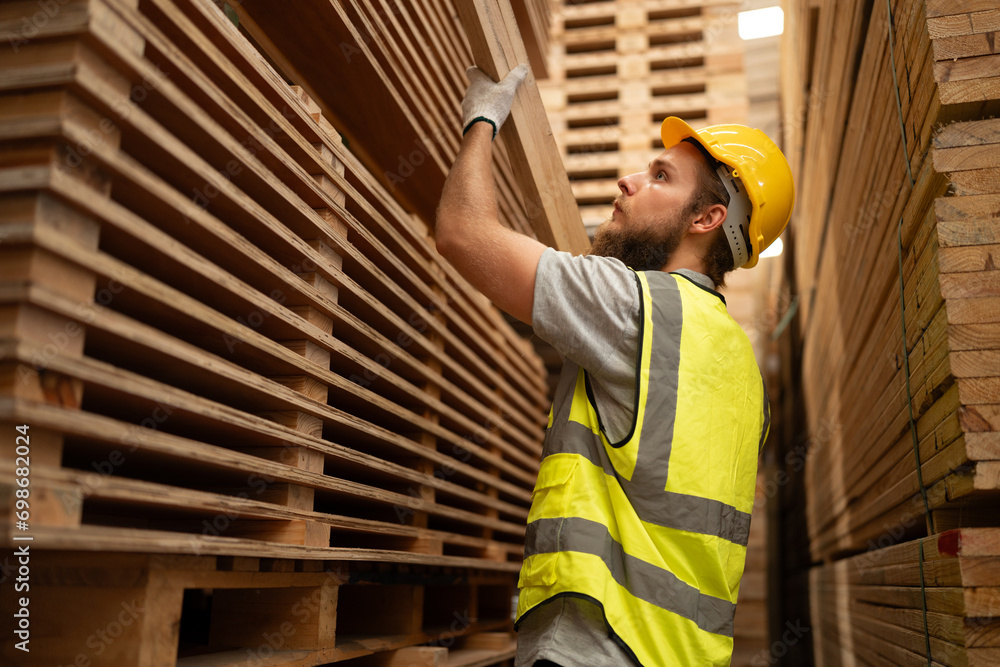 Caucasian business or craft man checking and holding timber with stock ...
