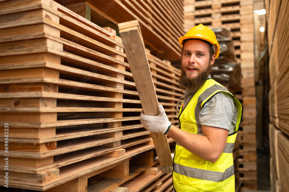 Caucasian business or craft man checking and holding timber with stock ...
